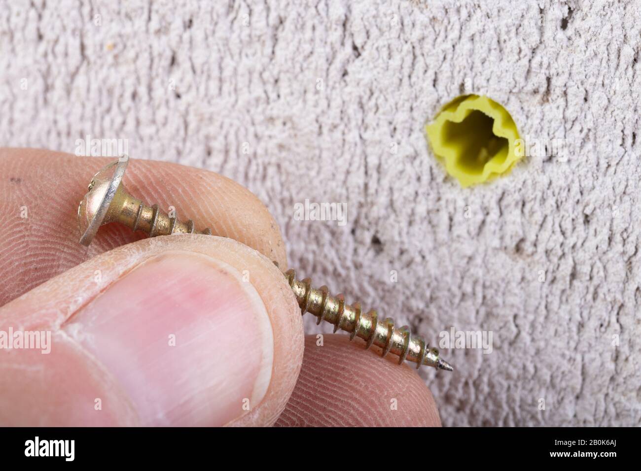 Hole in the wall, screw and dowel for fixing in concrete. Wall mounting ...