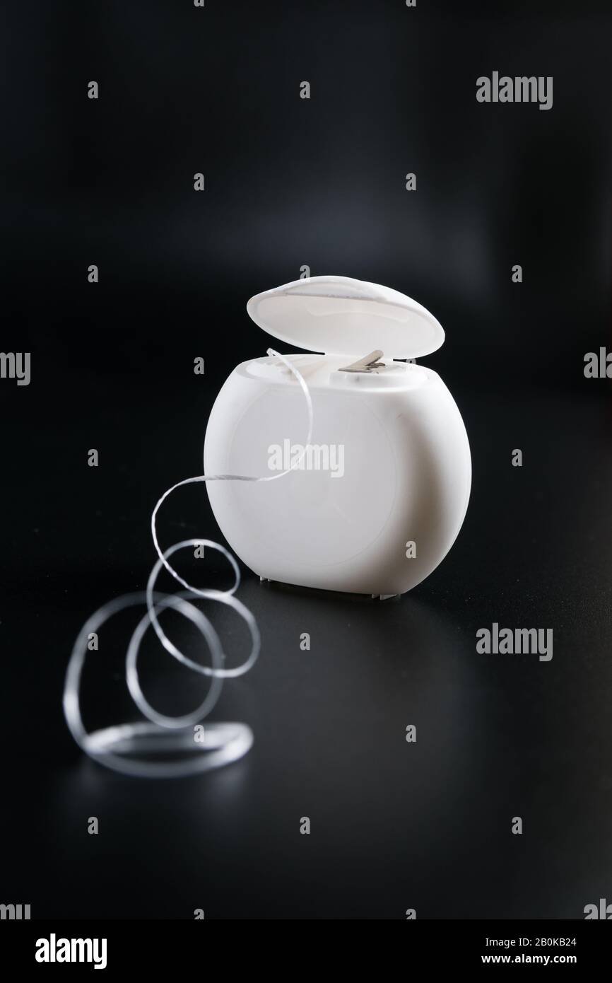 close-up, white dental floss on a black background Stock Photo - Alamy
