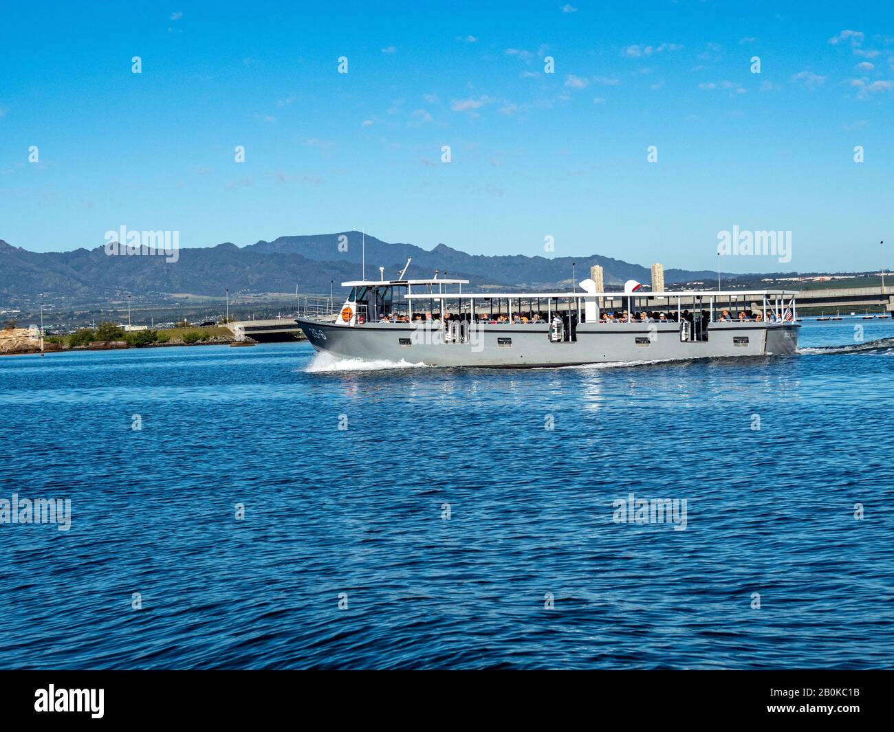 US Navy ship ferries tourists to the Arizona Memorial at Pearl Harbor ...