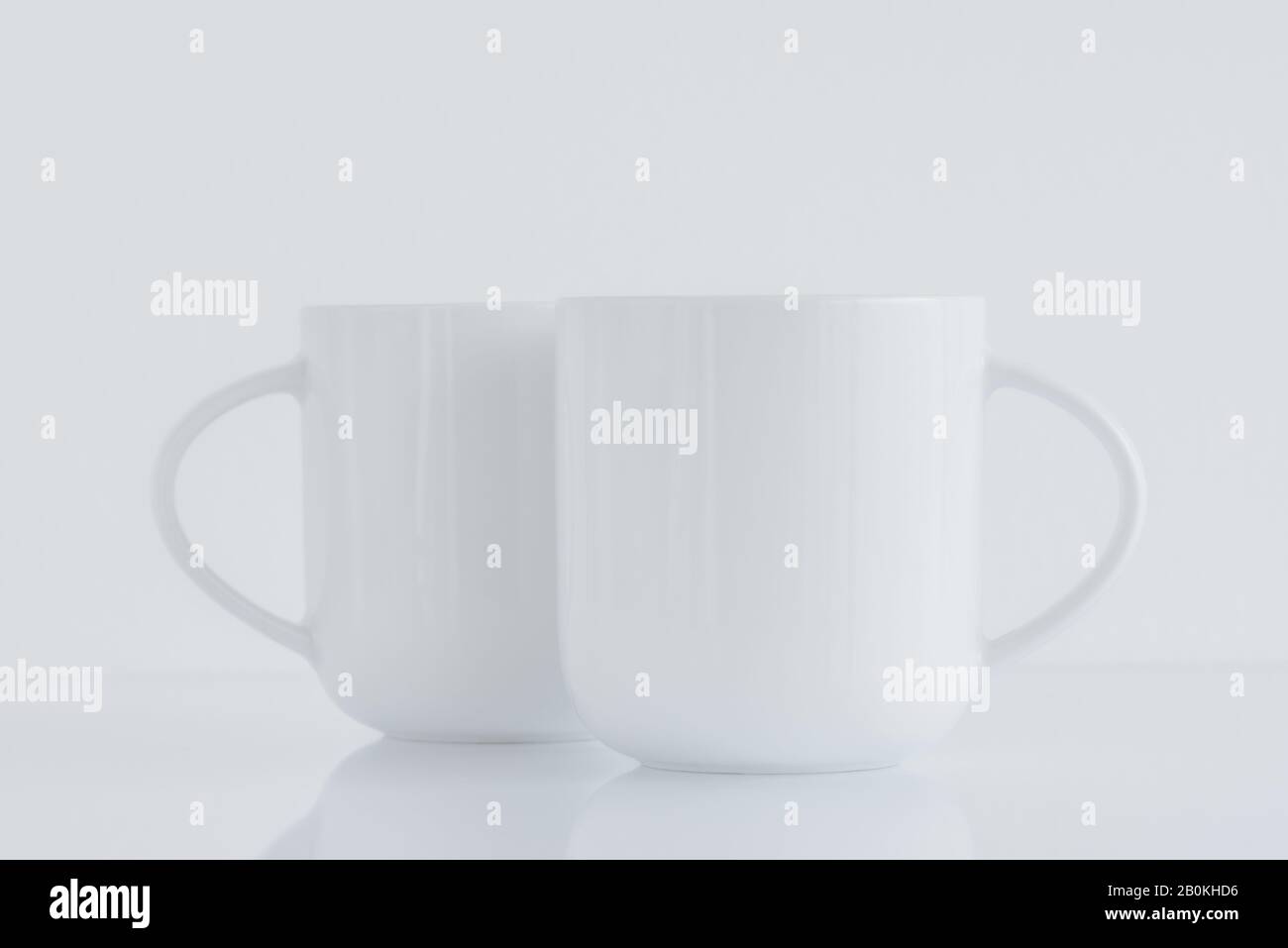 Two white teacups mock up with bright white copy space Stock Photo - Alamy