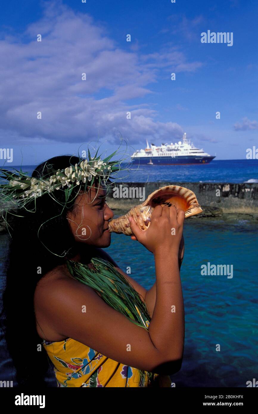 COOK ISLANDS, ATIU ISLAND, MS WORLD DISCOVERER,GIRL BLOWING INTO ...