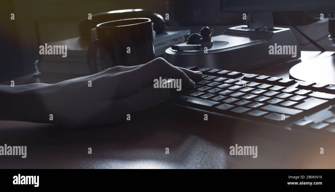 hands on computer keyboard, dark background Stock Photo - Alamy