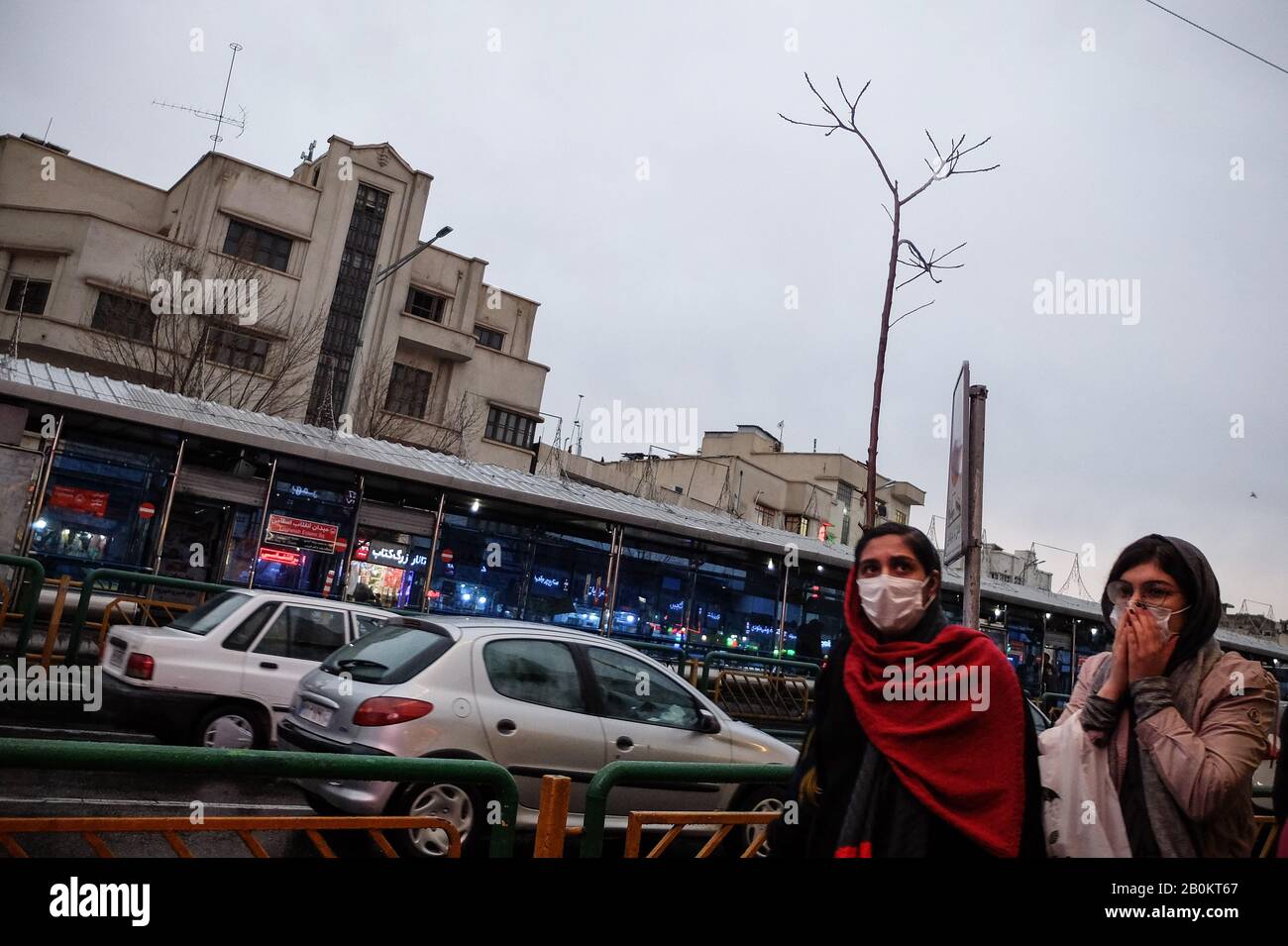 Tehran, Iran. 20th Feb, 2020. Iranians wearing protective masks walk in ...