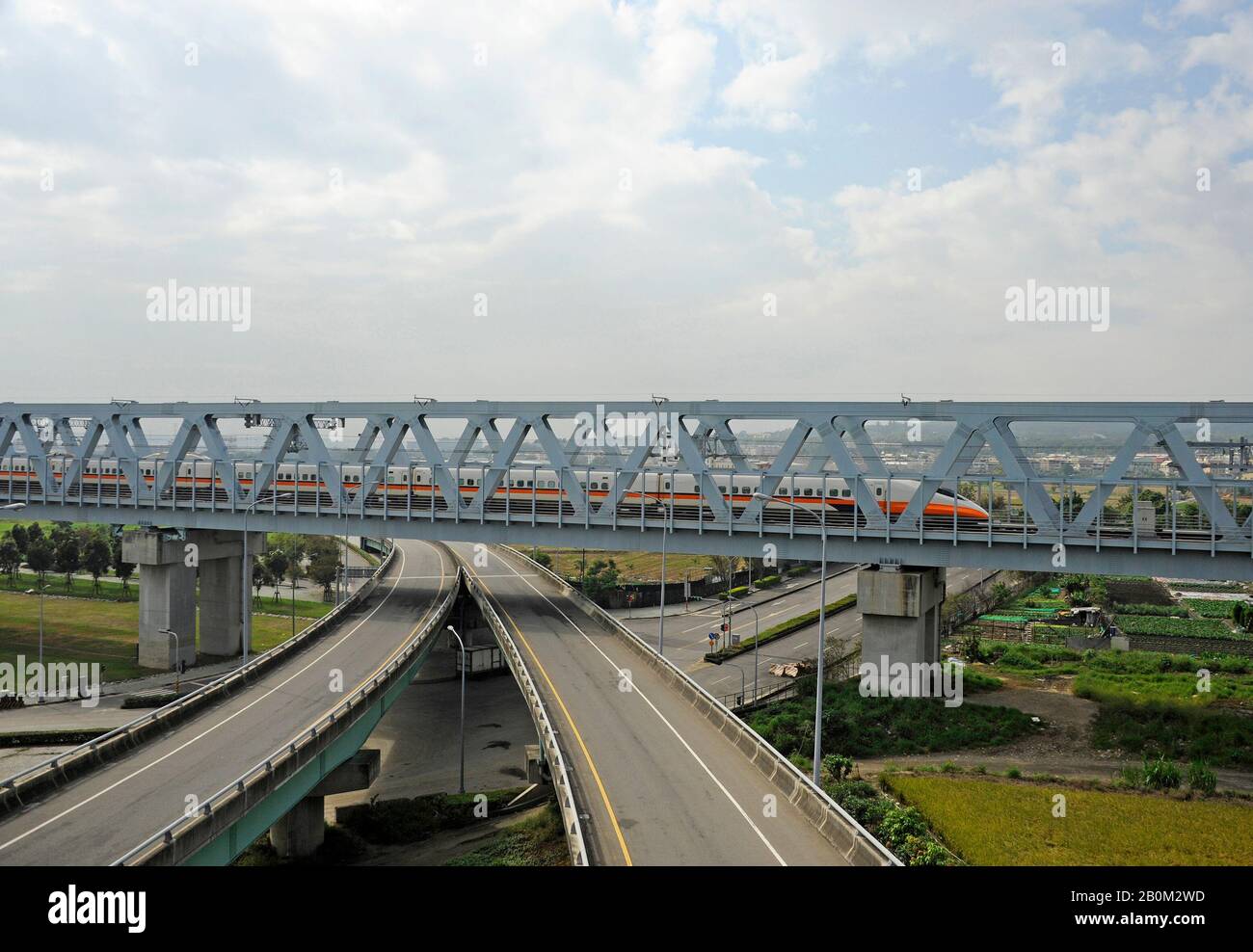 High Speed HSR bullet train leaves Taichung station on a cantilever ...