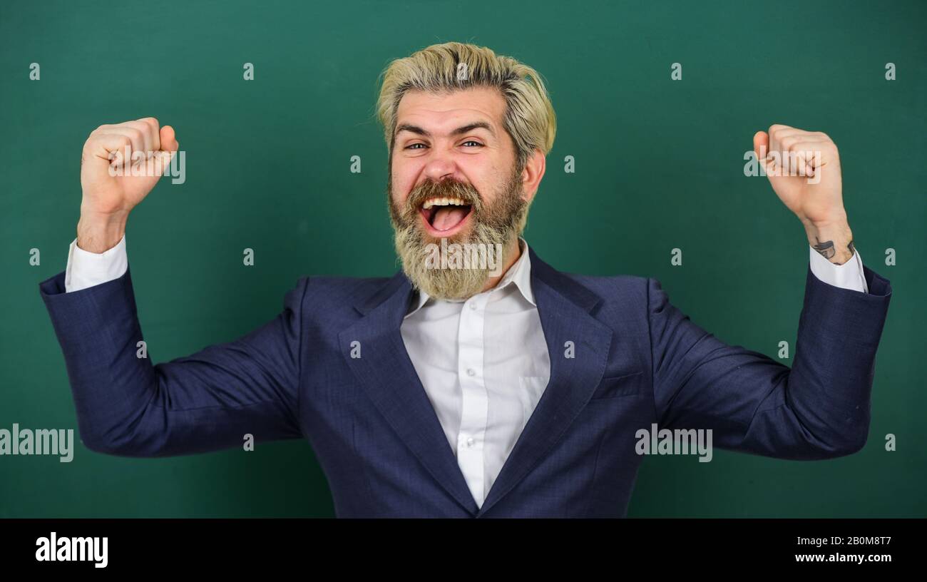 Always winner. Happy winner at green chalkboard. Bearded man make ...