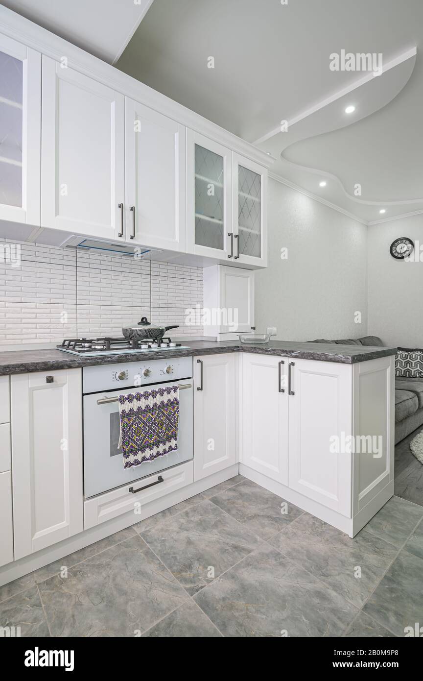 Modern white kitchen interior, front view Stock Photo - Alamy