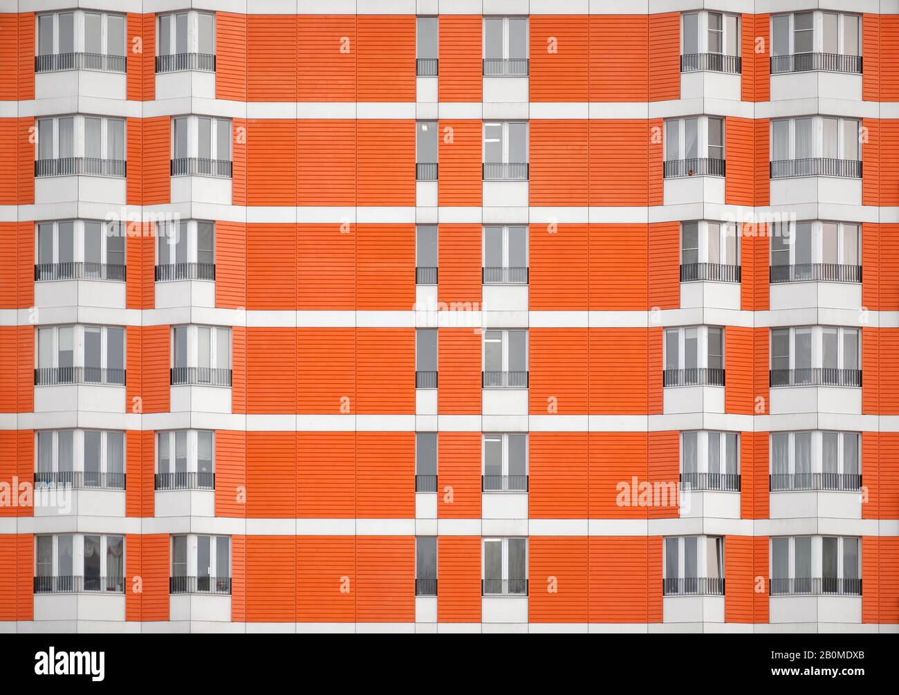 Many Windows on a orange residential building Stock Photo - Alamy
