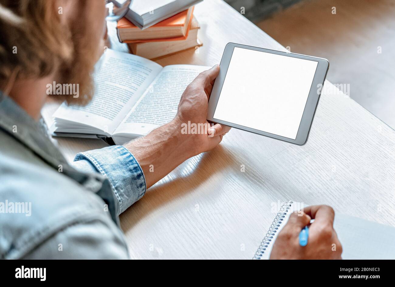 Student hold modern digital tablet make notes in notebook empty mock up ...