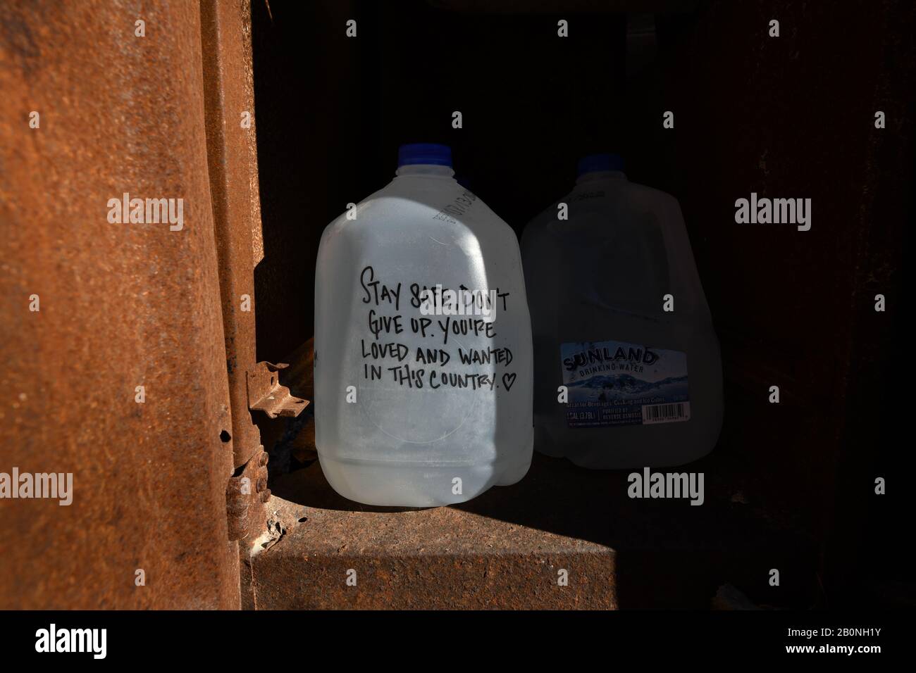 Containers of water have been placed at an abandoned structure along a ...