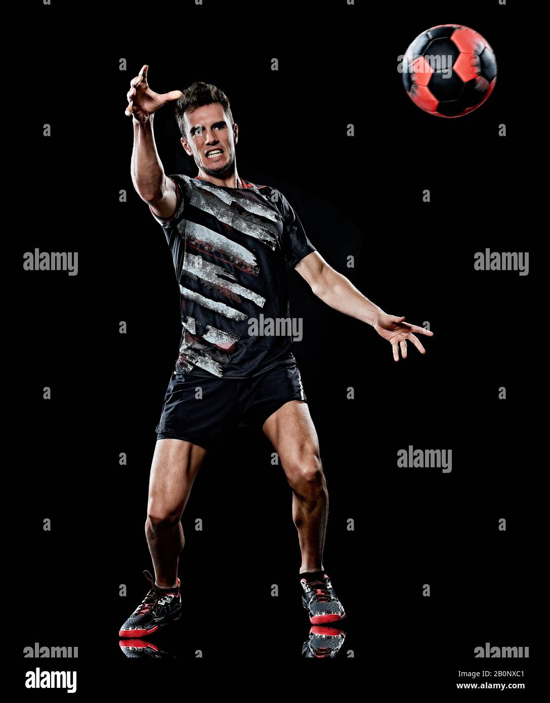 one caucasian young handball player man in studio isolated on black ...