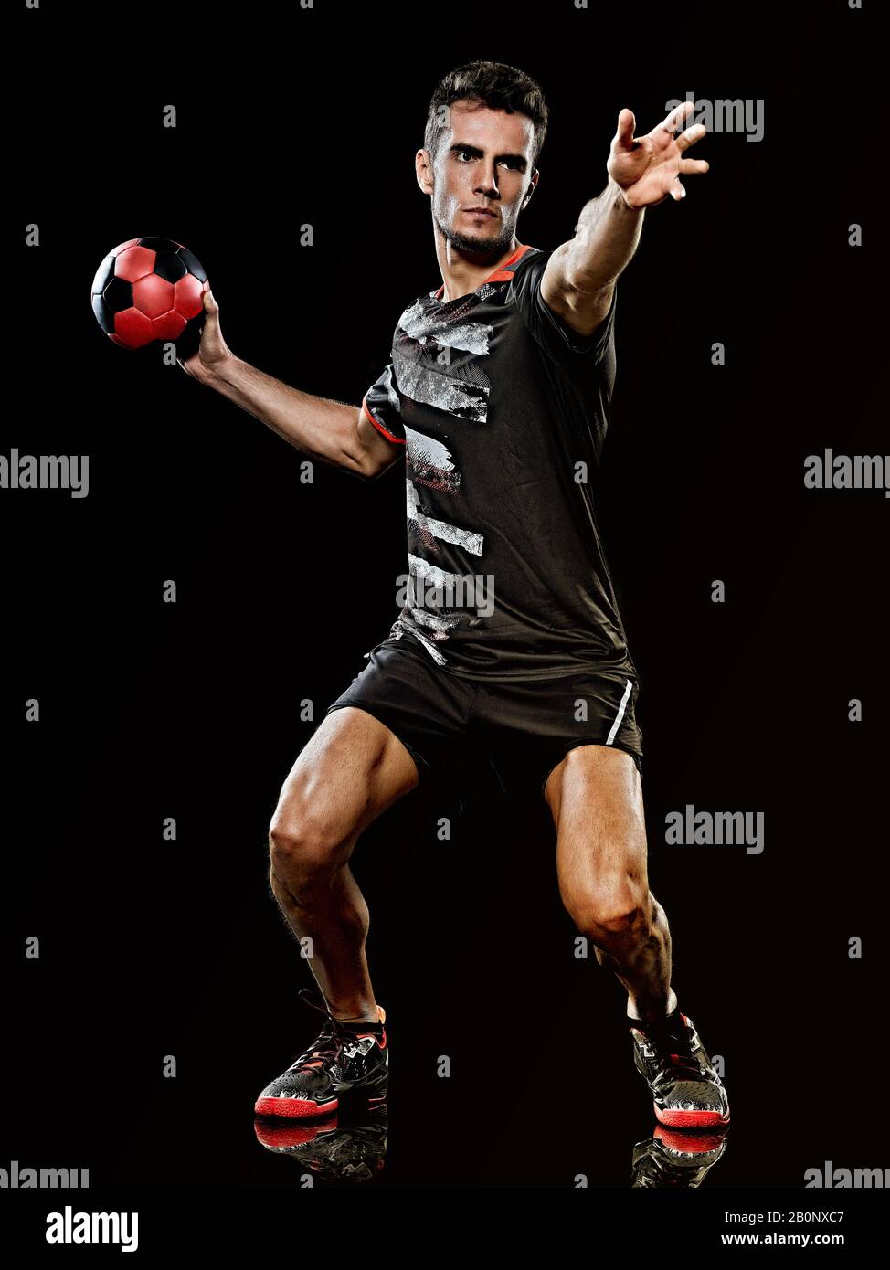 one caucasian young handball player man in studio isolated on black ...
