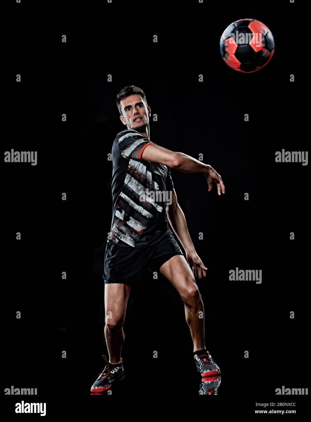 one caucasian young handball player man in studio isolated on black ...