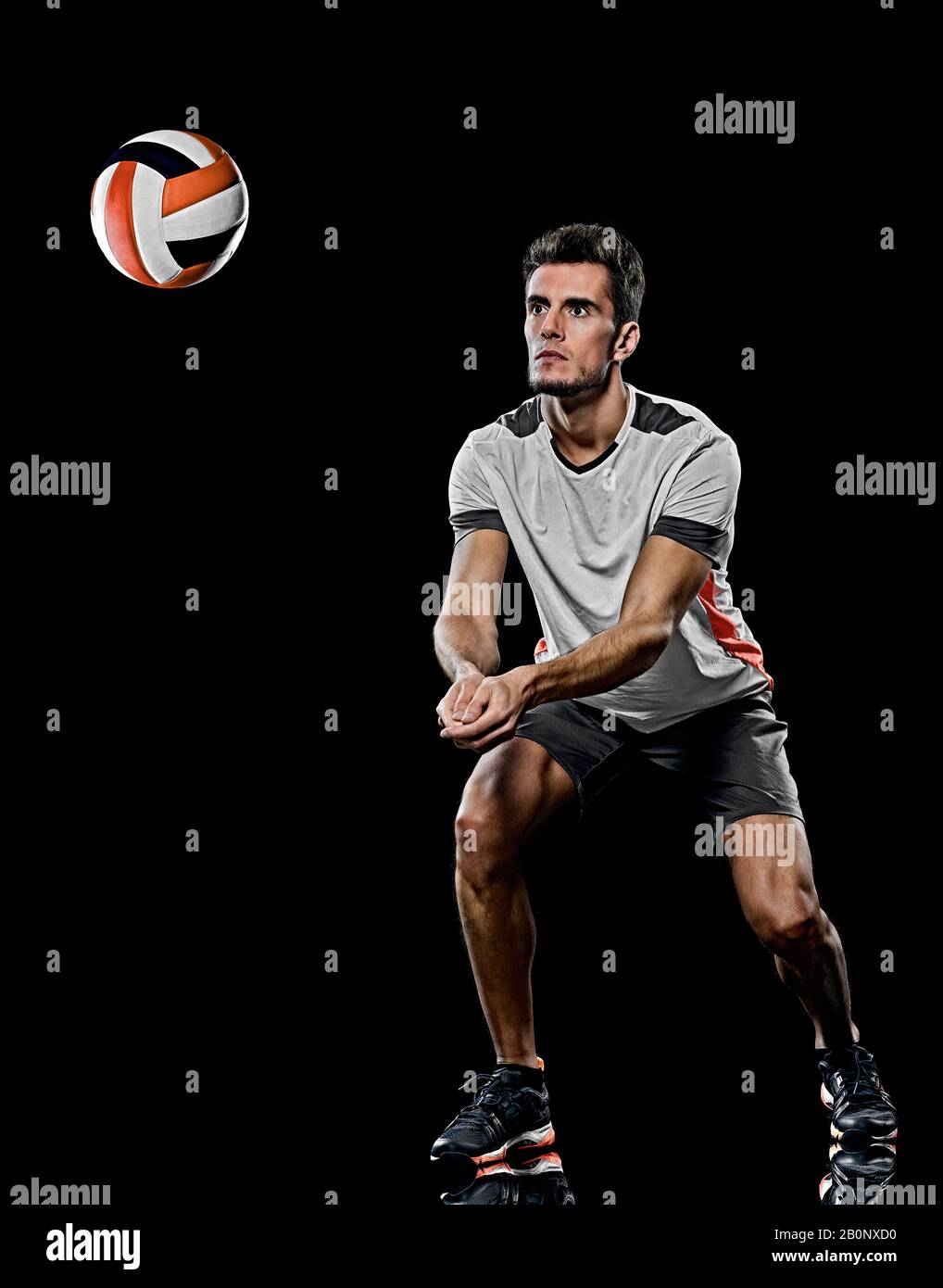 one caucasian young volley ball player man in studio isolated on black ...