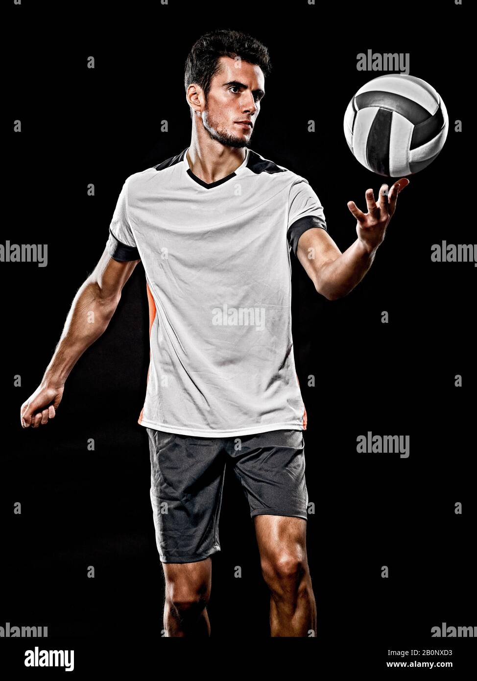 one caucasian young volley ball player man in studio isolated on black ...