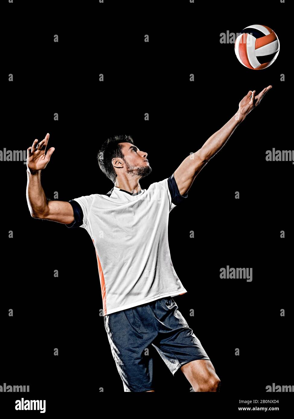 one caucasian young volley ball player man in studio isolated on black ...