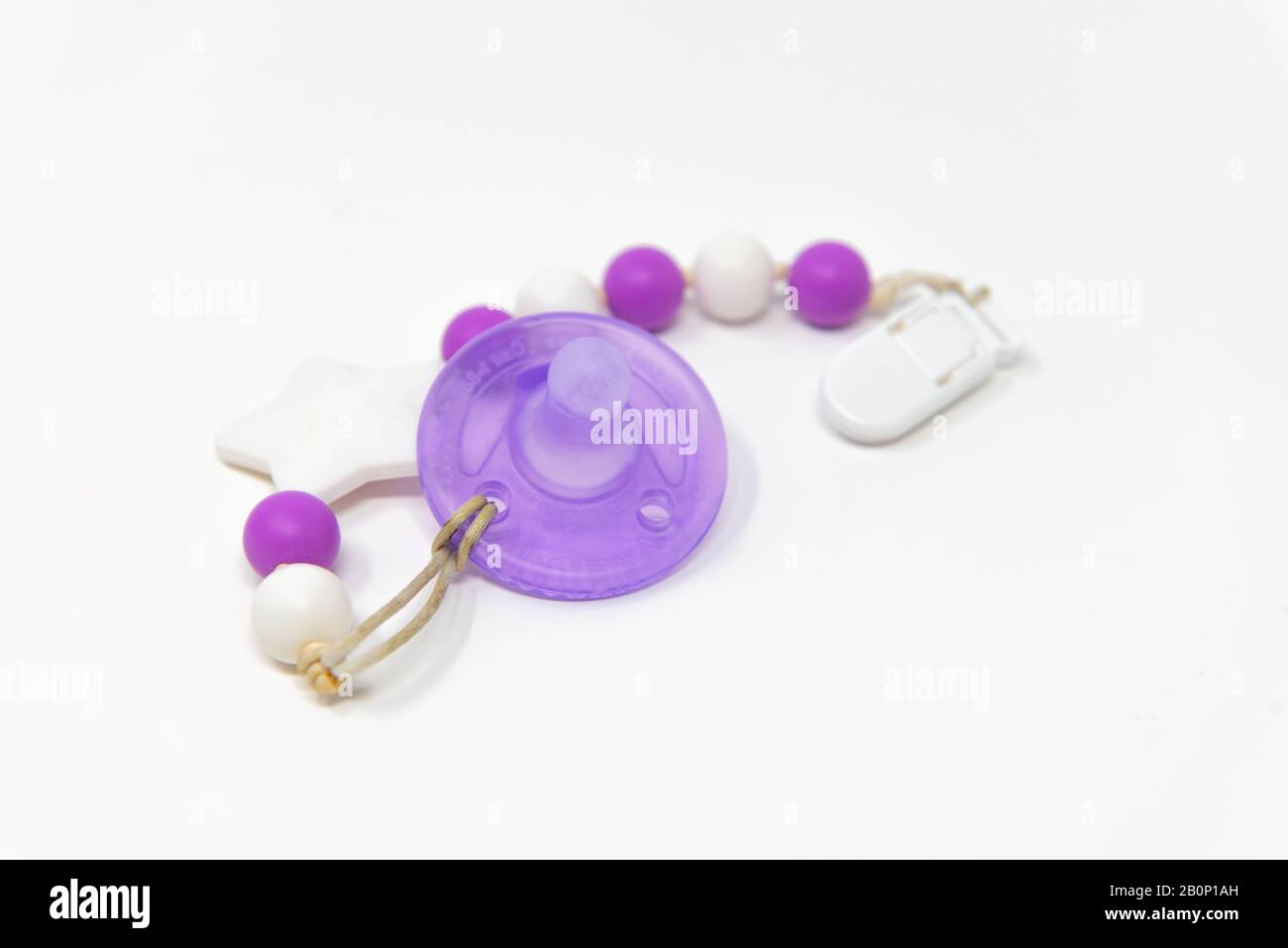 isolated purple pacifier on white background Stock Photo - Alamy