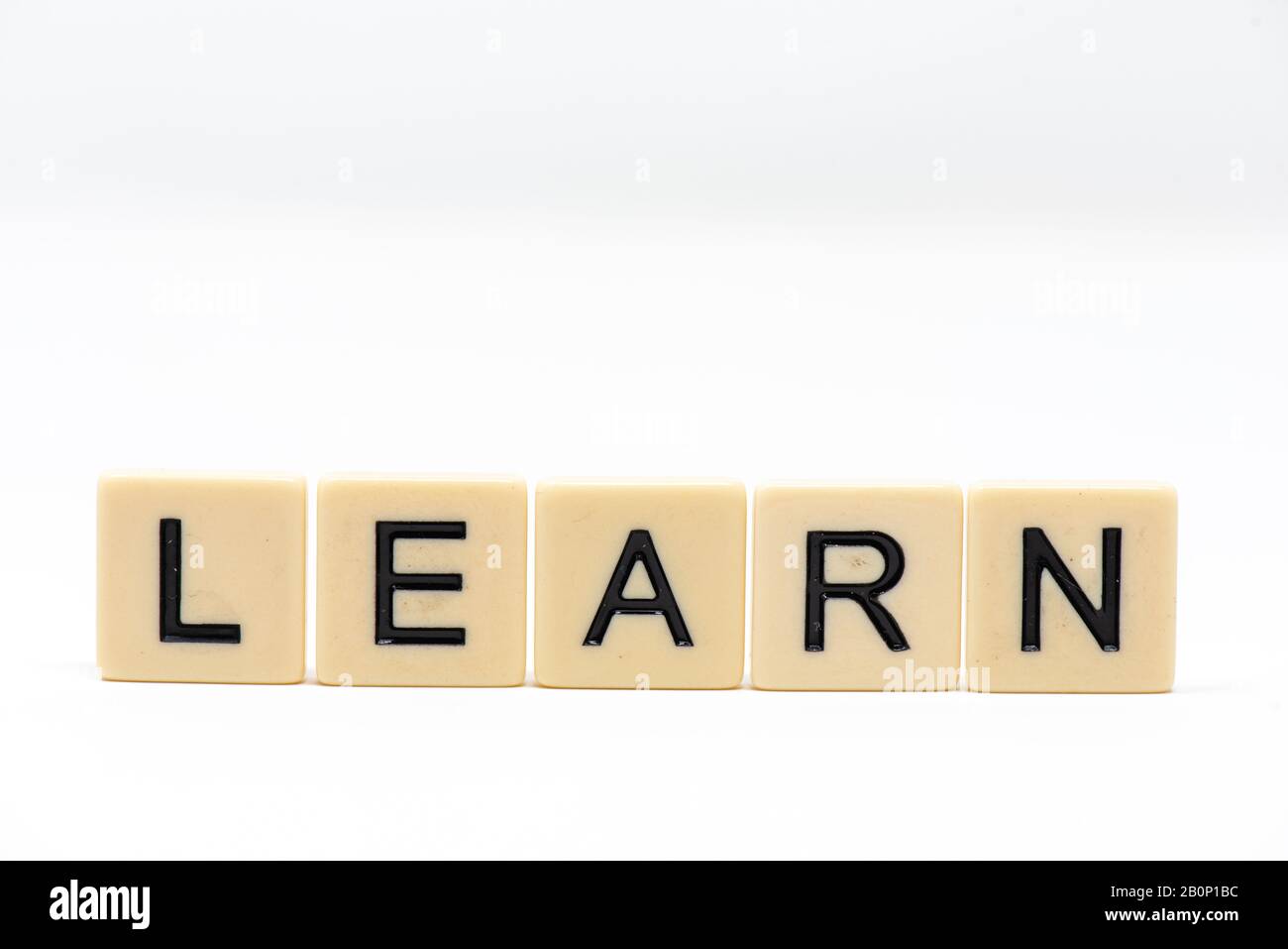 The Word LEARN spelled using letter tiles on white background Stock ...