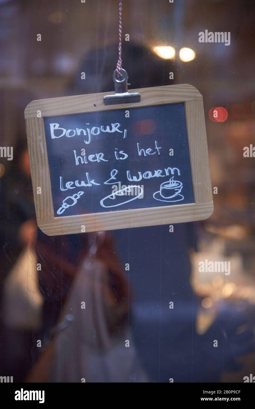 Close up of drawings and sign displayed on the window of a Dutch bakery ...