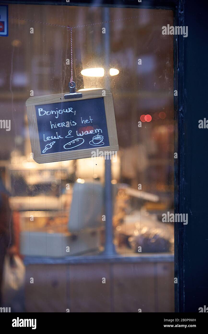 Close up of drawings and sign displayed on the window of a Dutch bakery ...