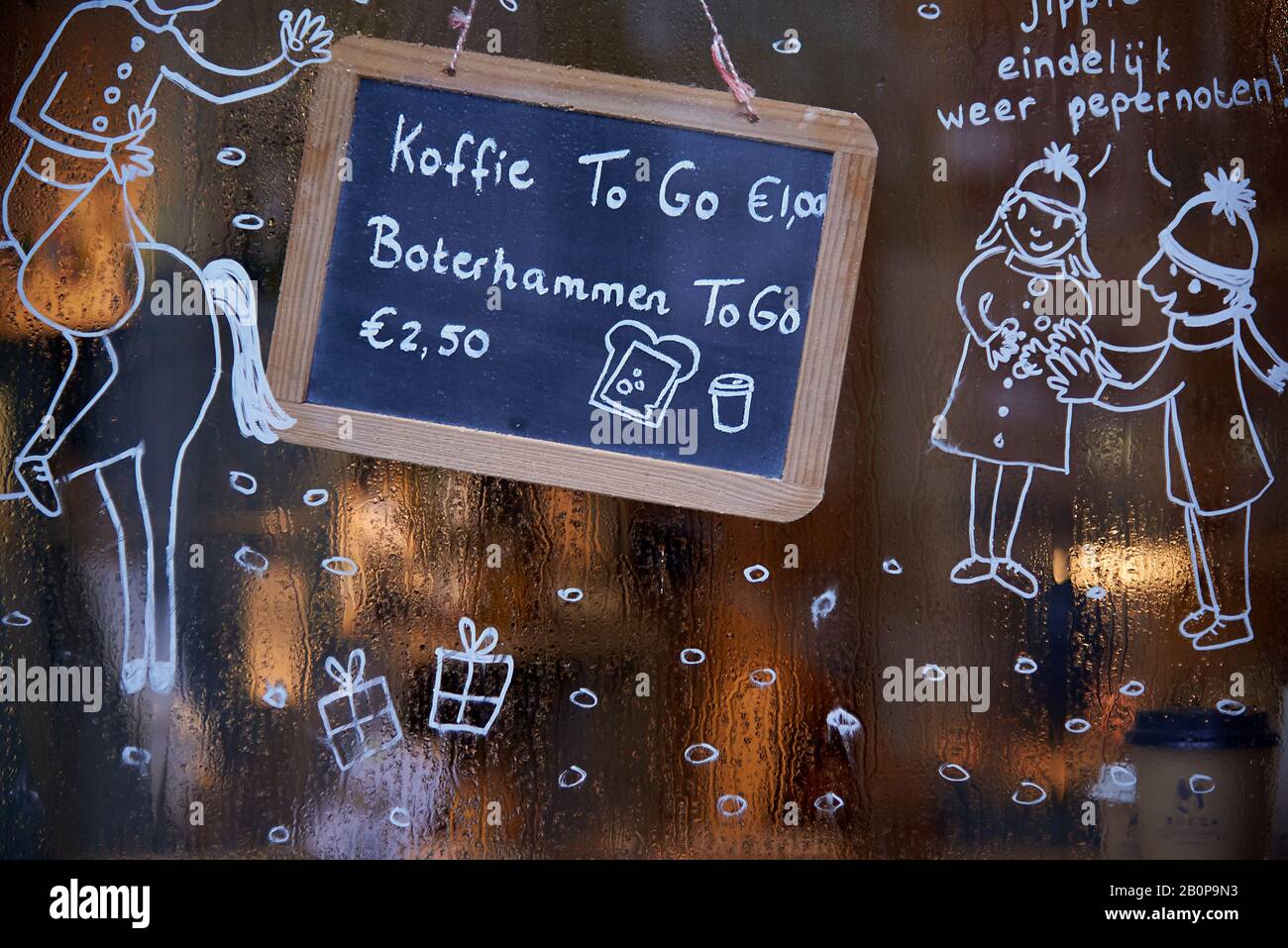 Close up of drawings and sign displayed on the window of a Dutch bakery ...