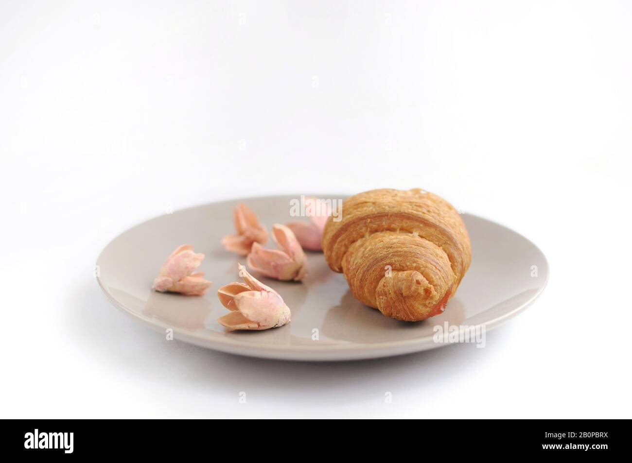 Croissant with decorated flowers in the grey plate horizontal view ...