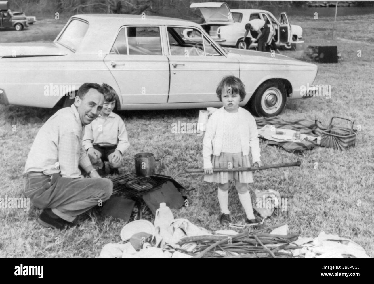 A 1967 image of a young Australian family boiling a billy over a wood ...