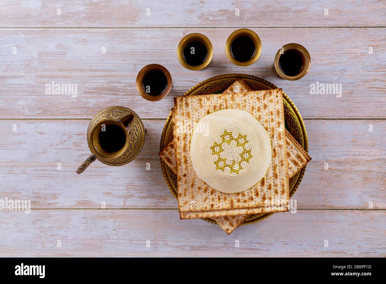 Matzoh jewish passover bread in the traditional seder plate with kipah ...