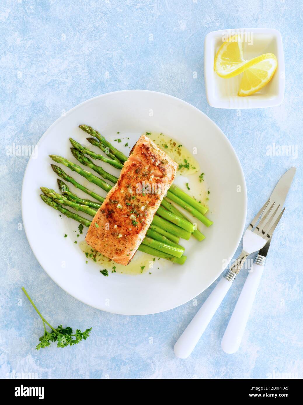 Fresh grilled wild coho salmon filet with lemon butter sauce on a bed ...