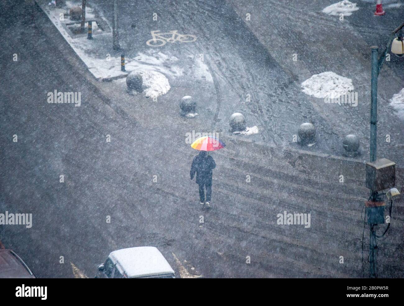 A pedestrian walks in heavy snow on the street in Shenyang City ...