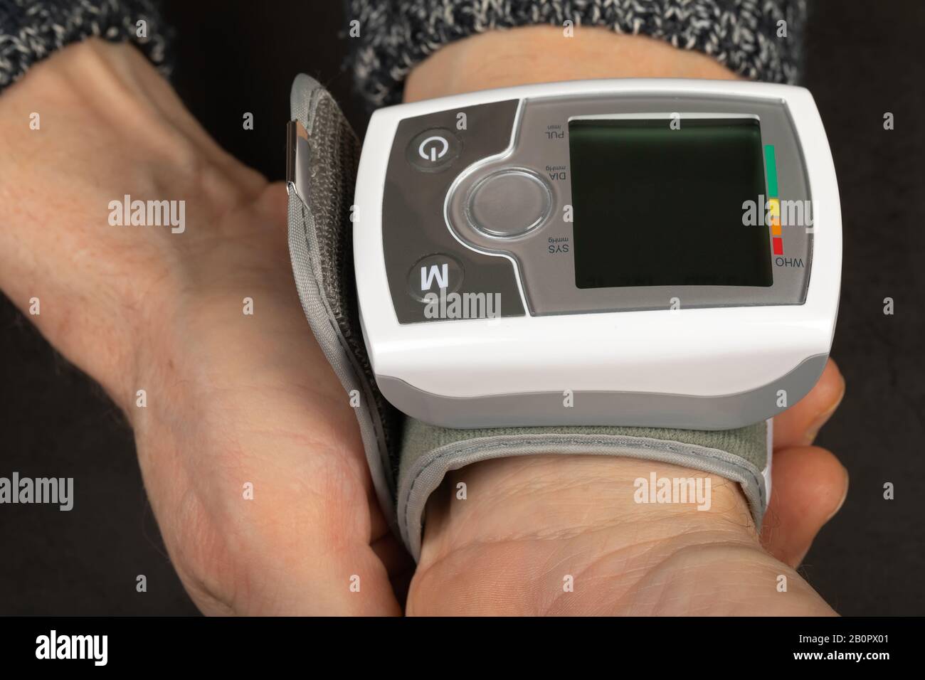 Blood pressure monitor on senior patient's hand Stock Photo - Alamy