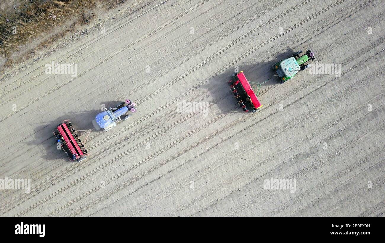 Chinese farmers plough and seed a wheat field in Sihaoqu Village, Yanqi ...