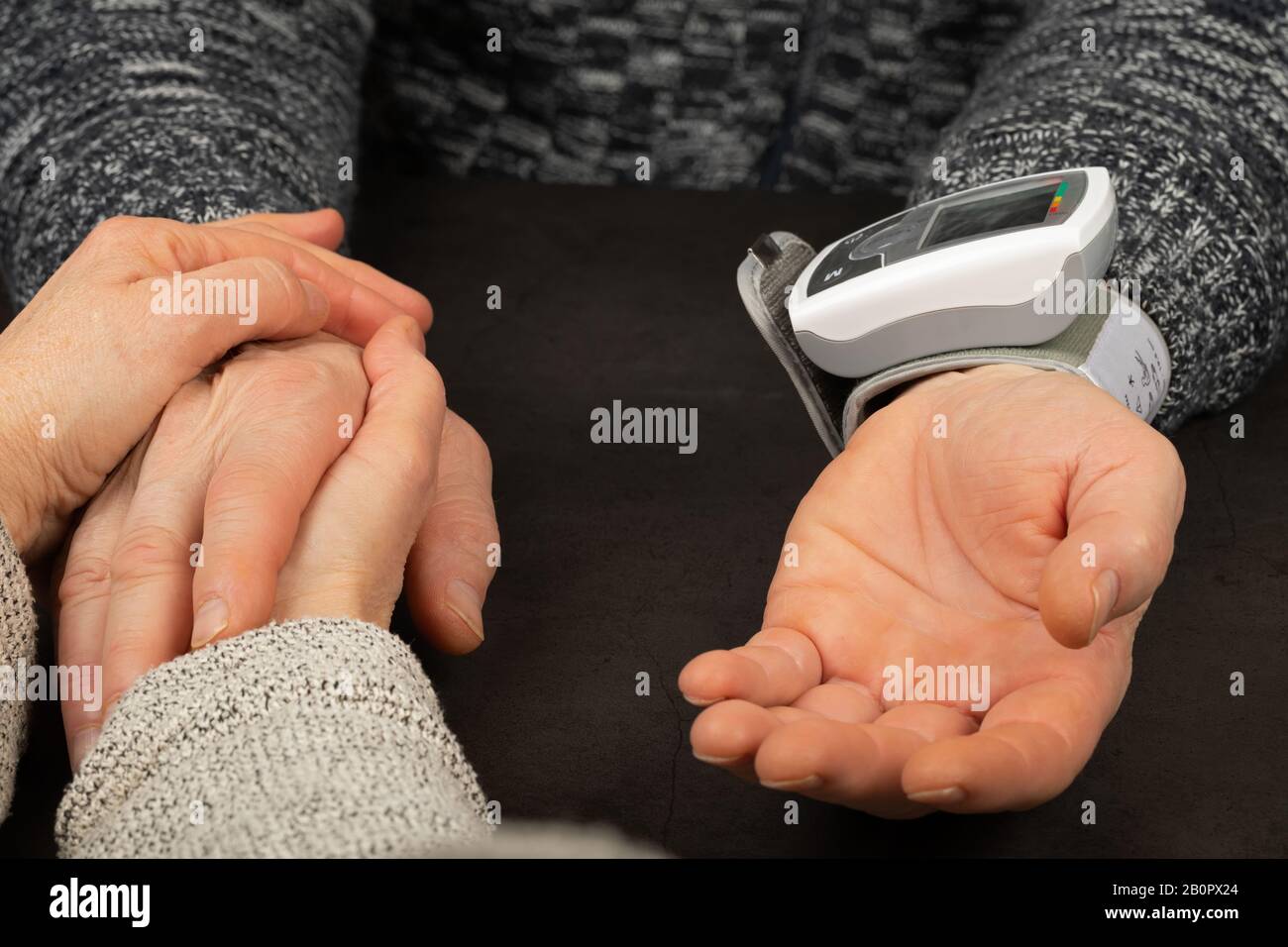 Blood pressure monitor on senior patient's hand Stock Photo - Alamy