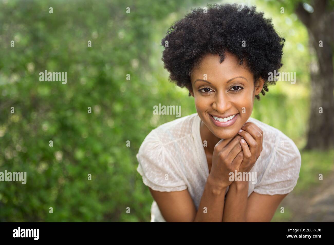 Beautiful woman smiling outside Stock Photo - Alamy