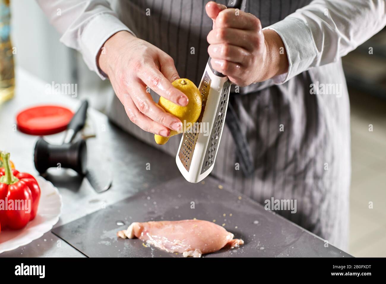 Chief chops and marinates chicken. Professional chef in a kitchen of ...