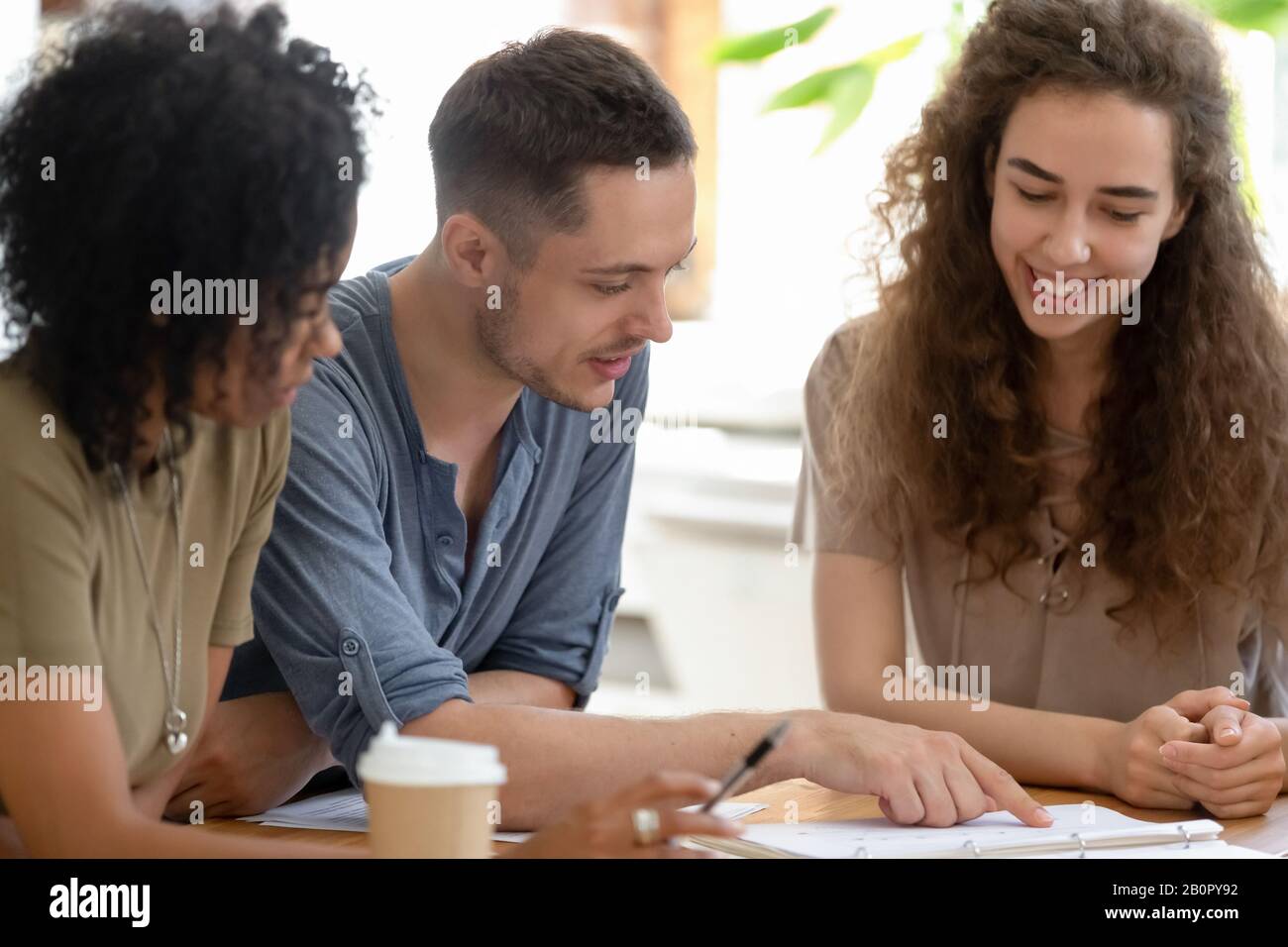 Smiling diverse students or employees working on project together ... Smiling diverse students or employees working on project together ...