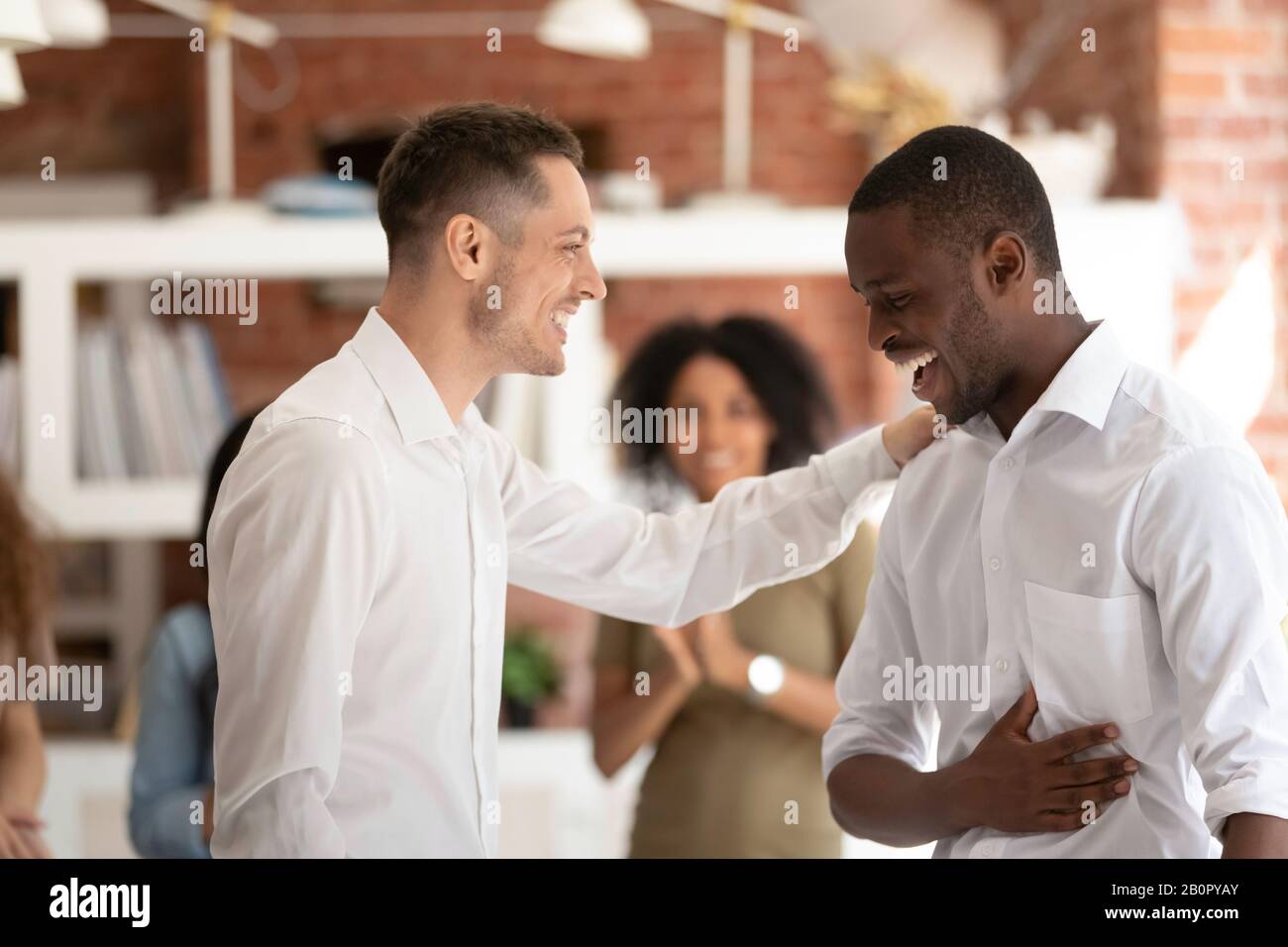 Executive manager businessman congratulating African American employee ...