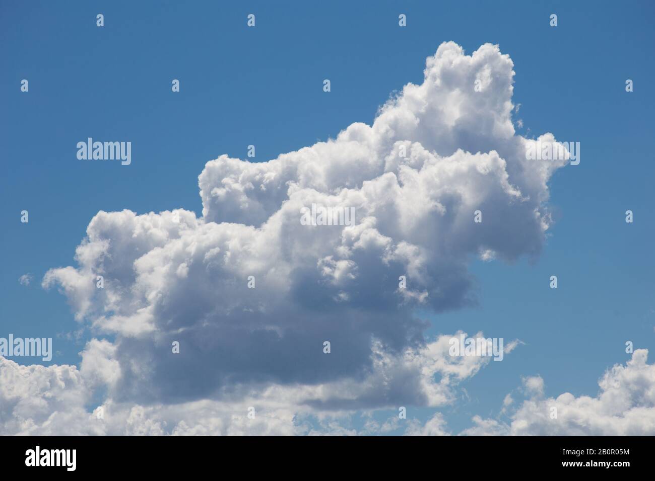 Big rain clouds in bright sunlights on a blue sky. Planet earth Stock ...