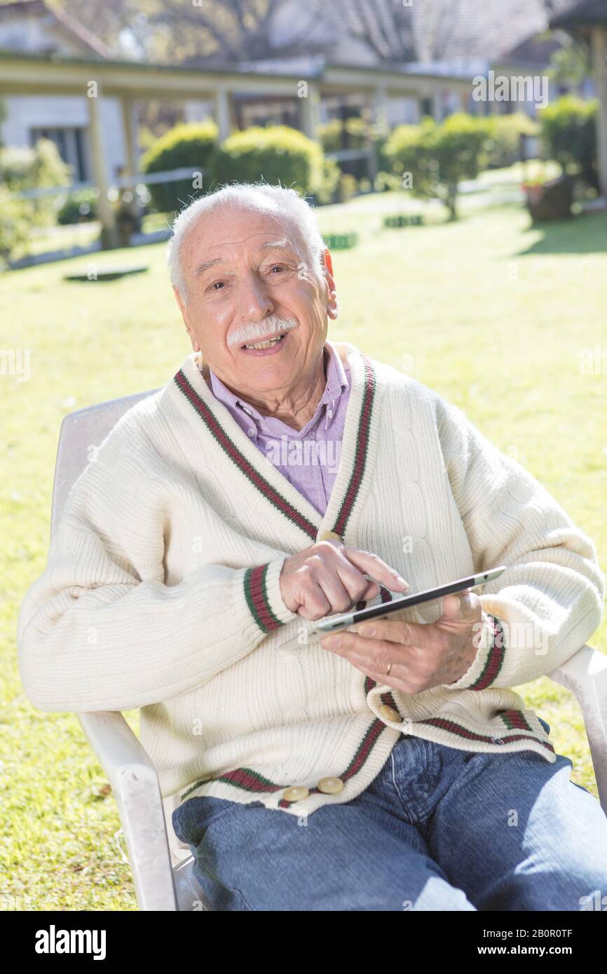 Smiling man in 60s using hi-res stock photography and images - Alamy