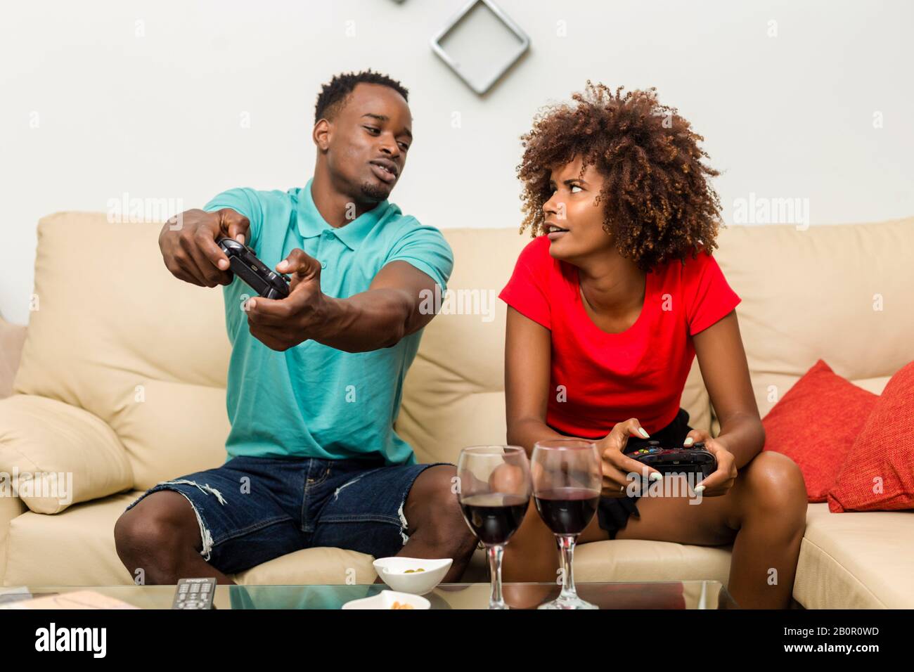 Black African American couple having fun playing video games Stock ...
