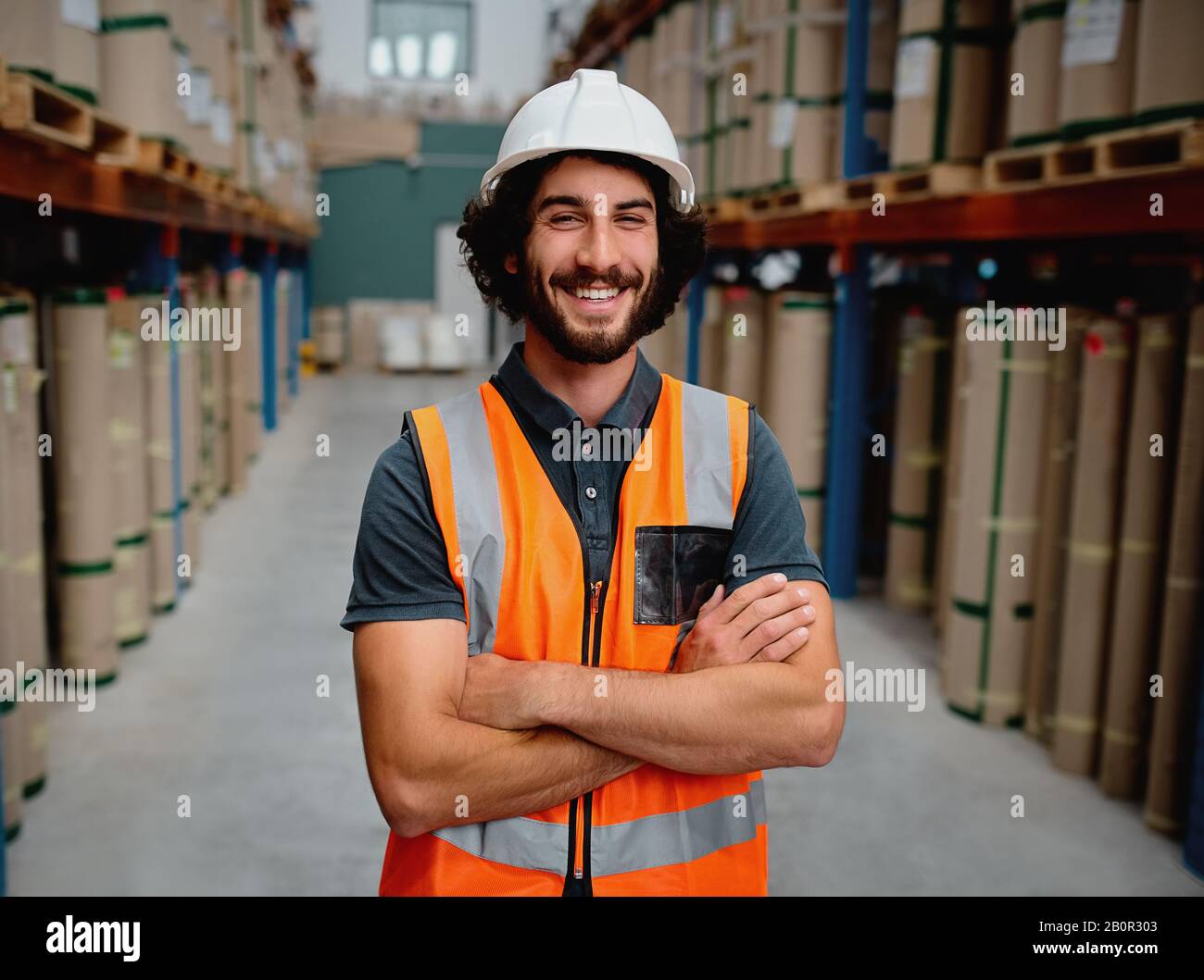 Portrait of cheerful supervisor in a warehouse for delivering and ...