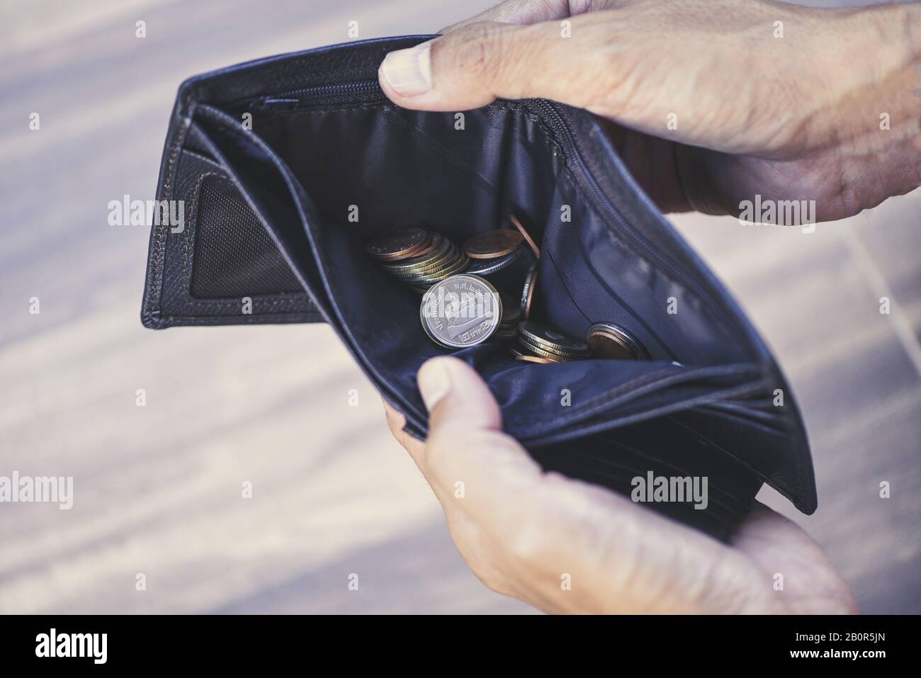 Coin in wallet and debt management concept / Empty wallet in the hands ...