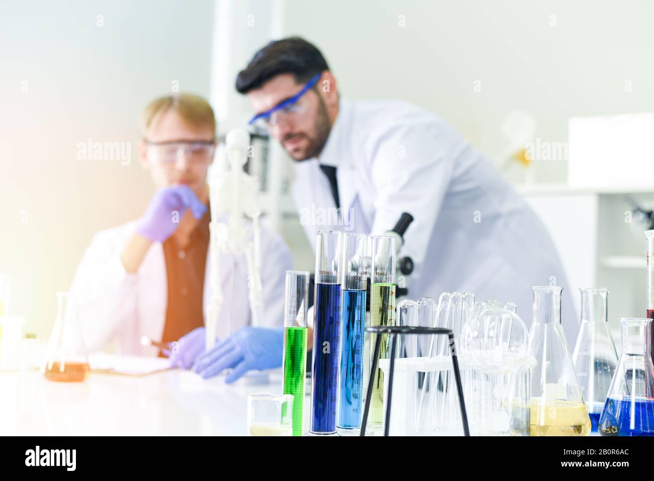 Man doctor as male scientist team doing some research working conduct experiments in modern ...