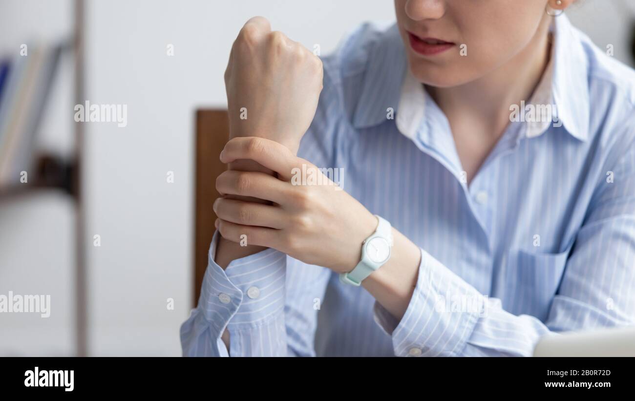Close up unhappy businesswoman holding writs, suffering from carpal ...