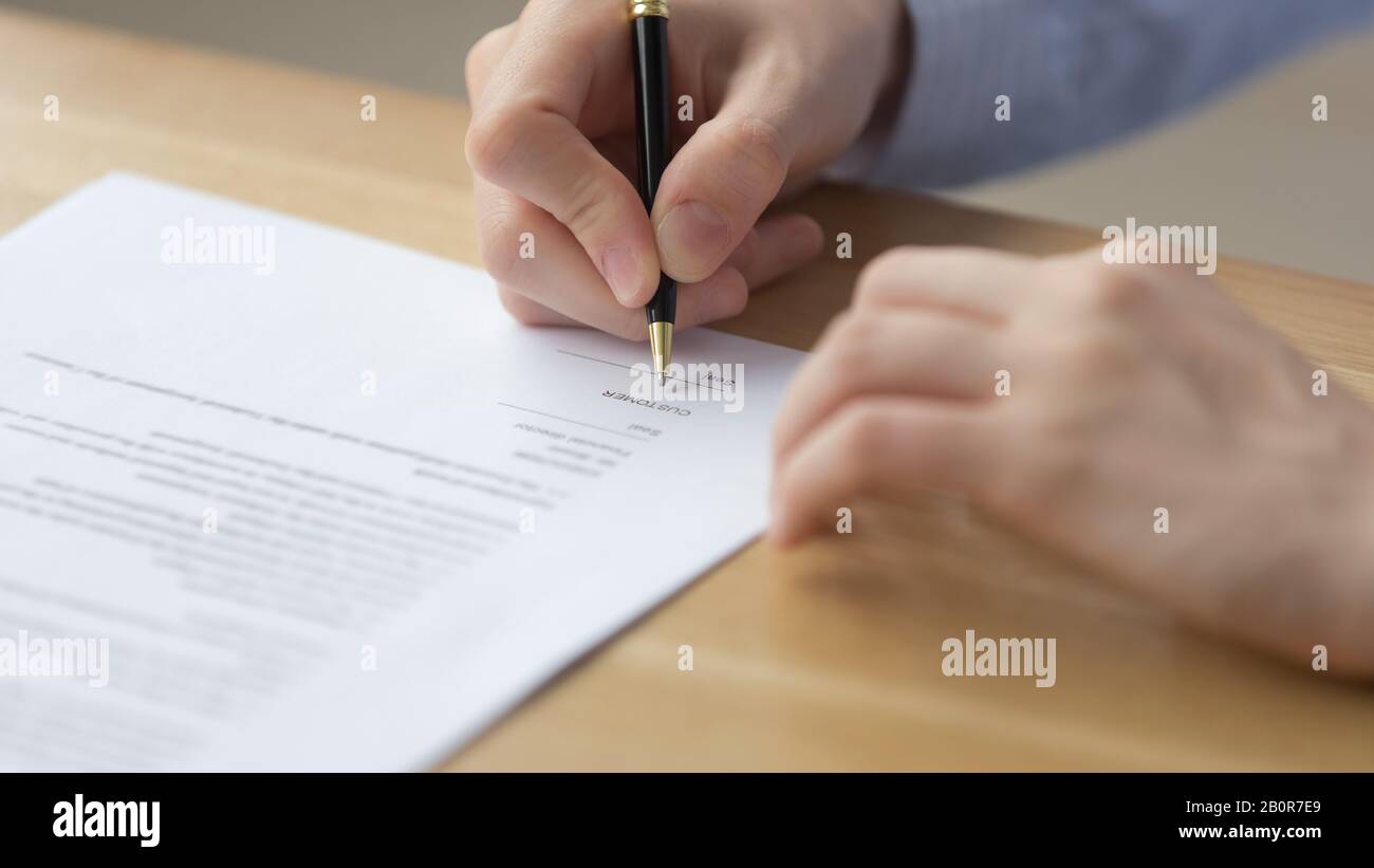 Close up businesswoman signing contract, putting signature on business ...