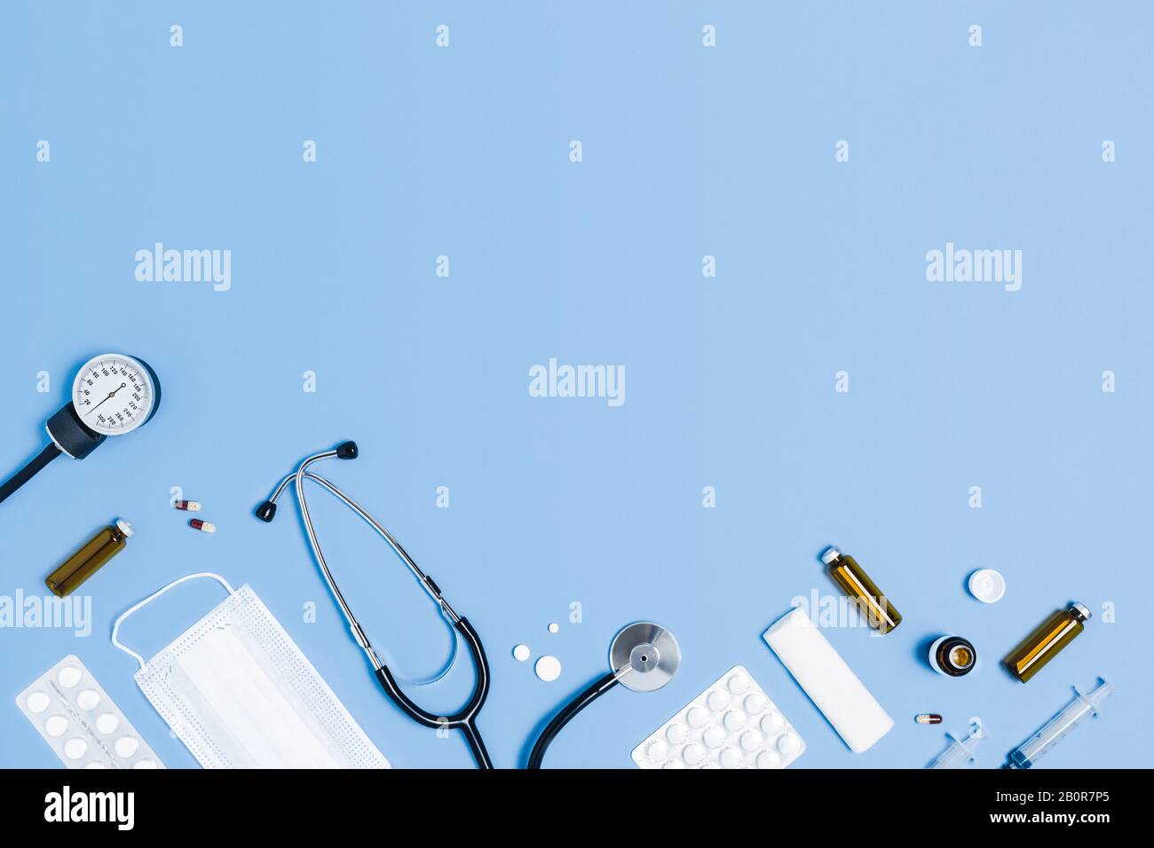 Medical blue background with different accessories: stethoscope ...