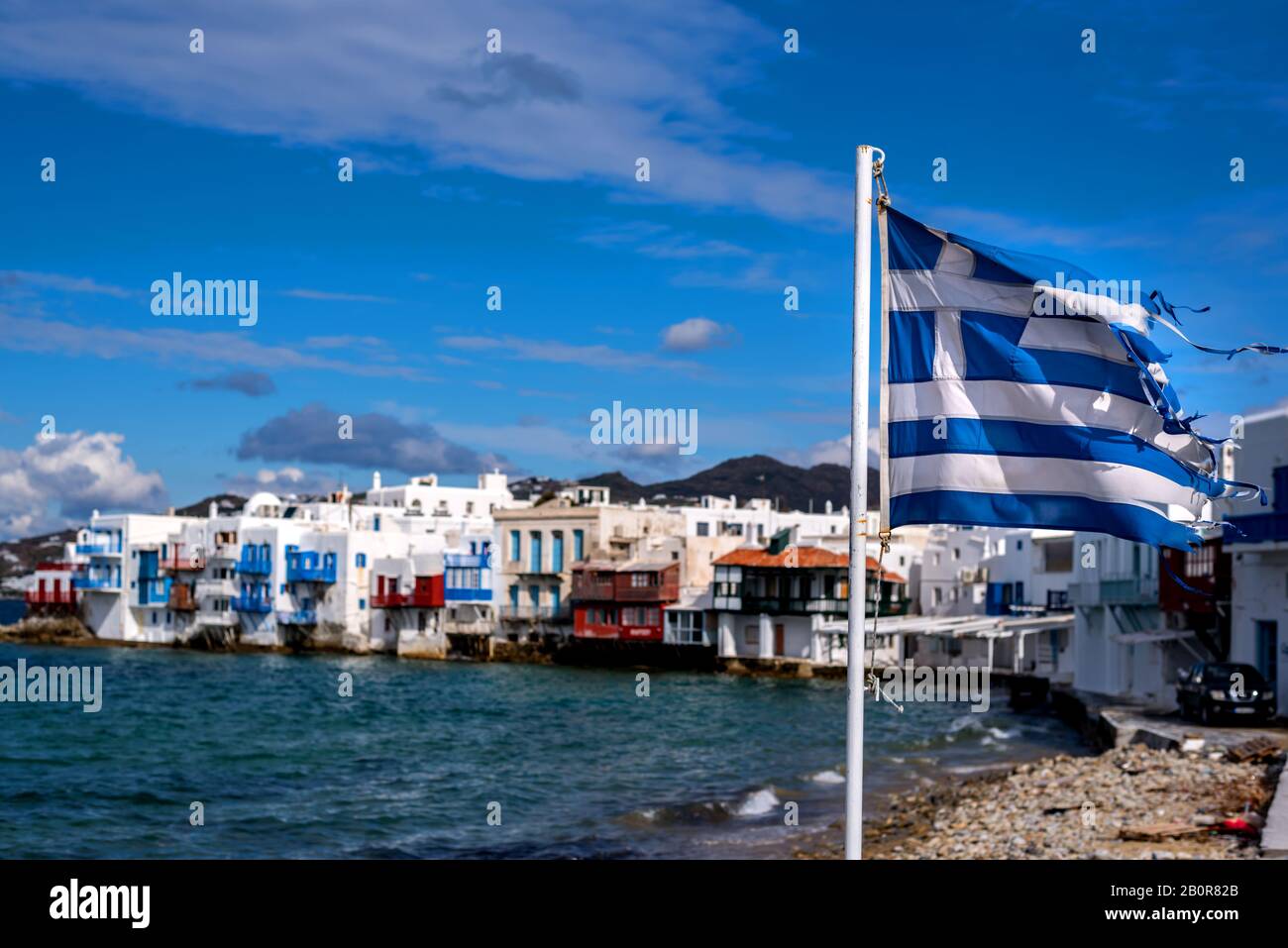 Greek flag waving in Little Venice bay of Mykonos town in Mykonos ...