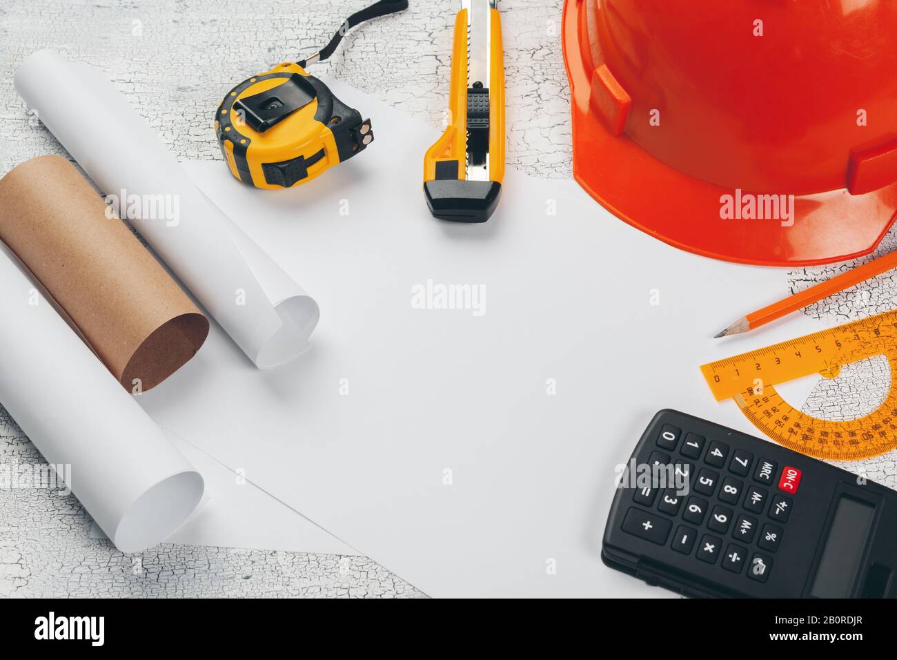 safety helmet and Scrolls of engineering drawings and supplies Stock ...