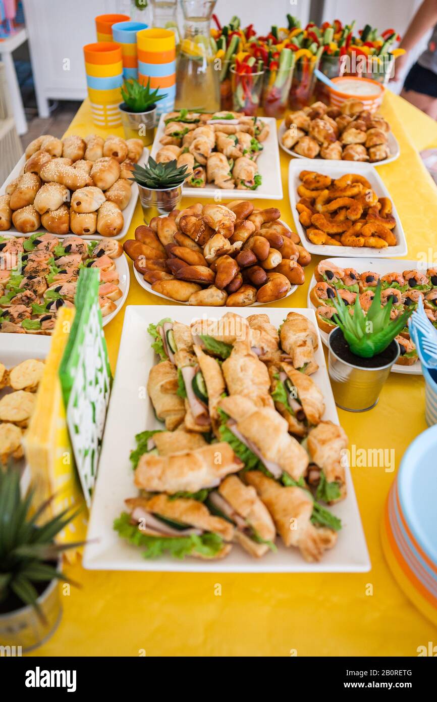 buffet for celebration birthday food on plates, home made sandwiches ...