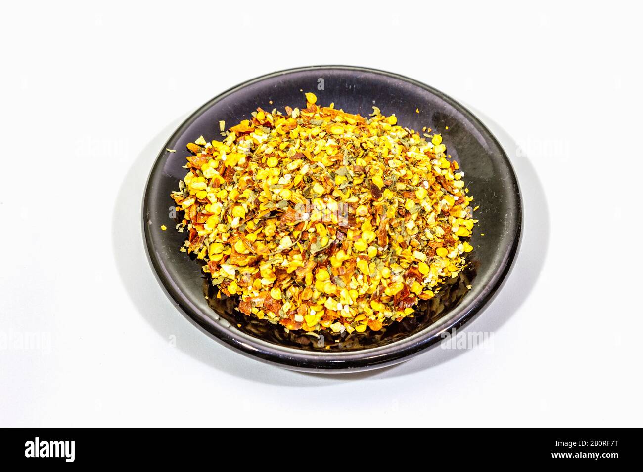 Hot seasoning in plate isolated on white background. Mix of different ...