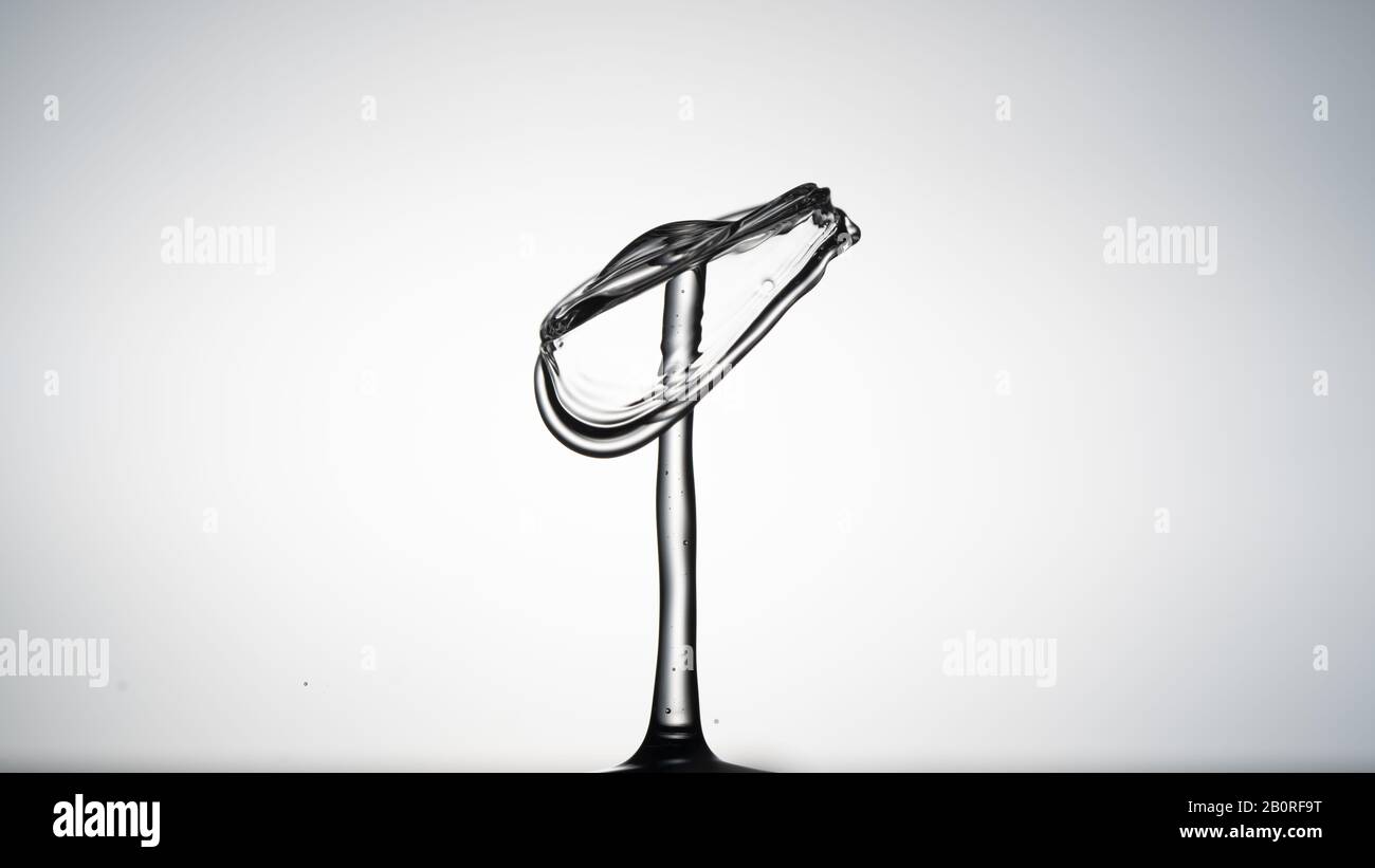 Close-up of a water drop falling on water surface Stock Photo - Alamy